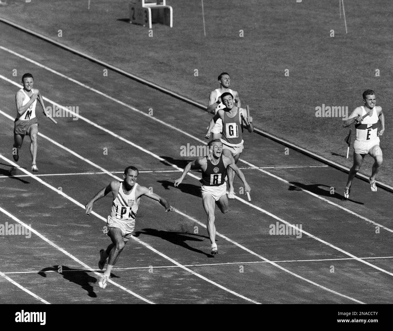 Bobby Morrow of he United States team crosses the finishing line to ...