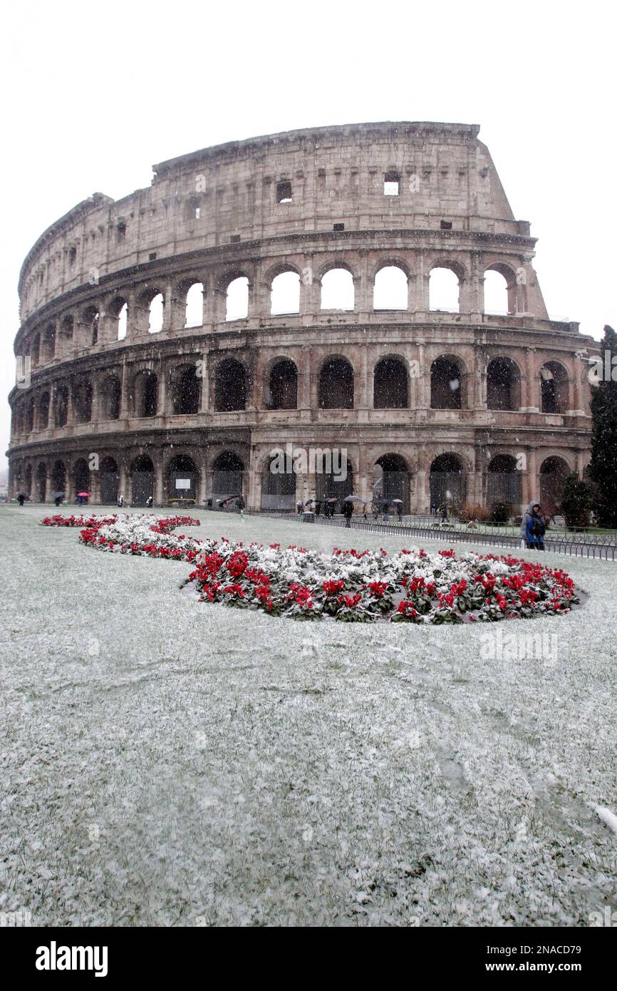 Snow surrounds the ancient Colosseum as snowflakes fell in downtown ...