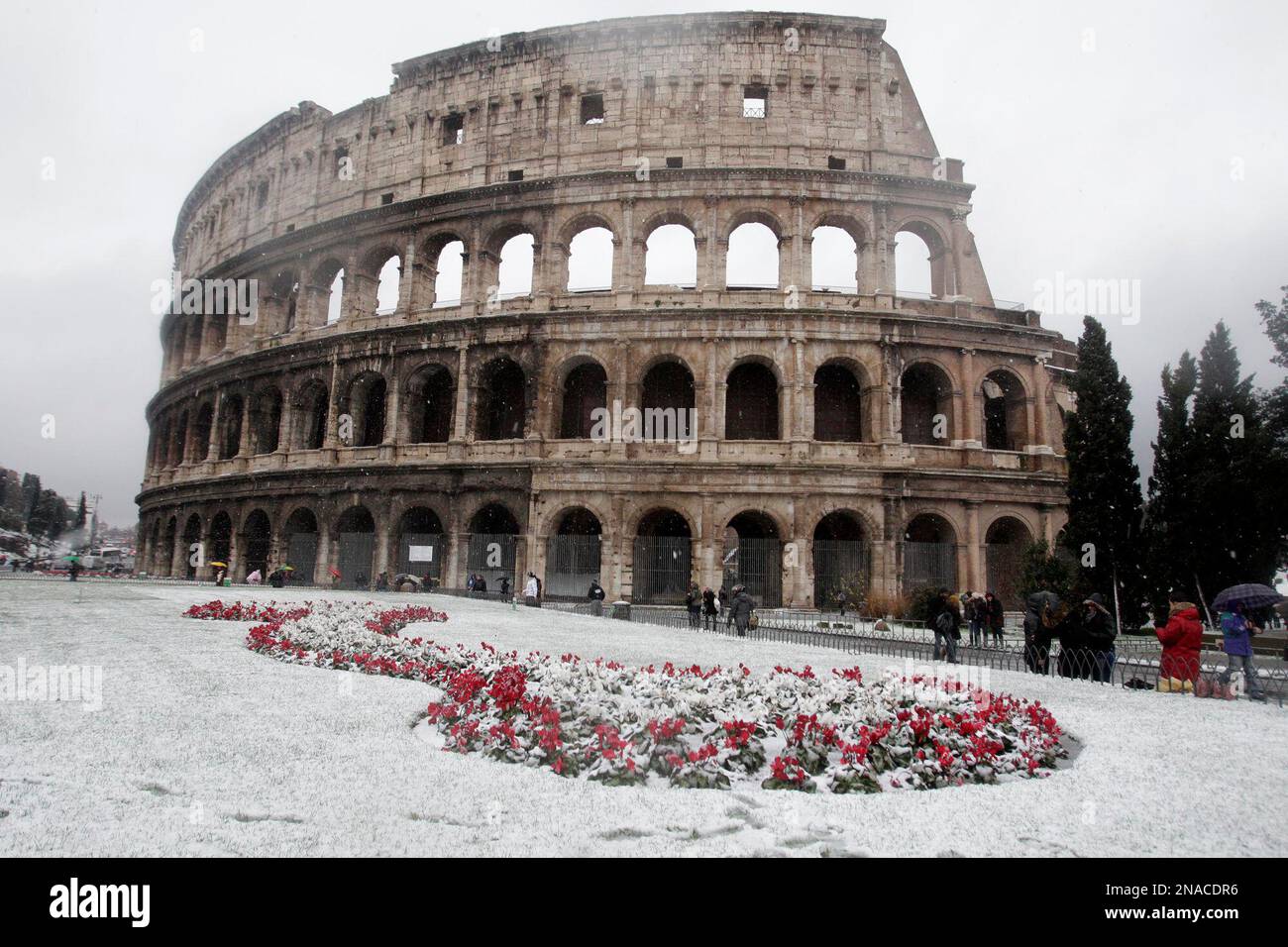 Snow surround the ancient Colosseum as snowflakes fell in downtown Rome ...