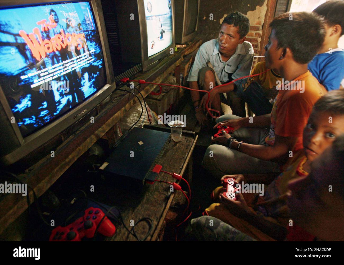 Indonesian youths play video games at a slum in Jakarta, Indonesia ...