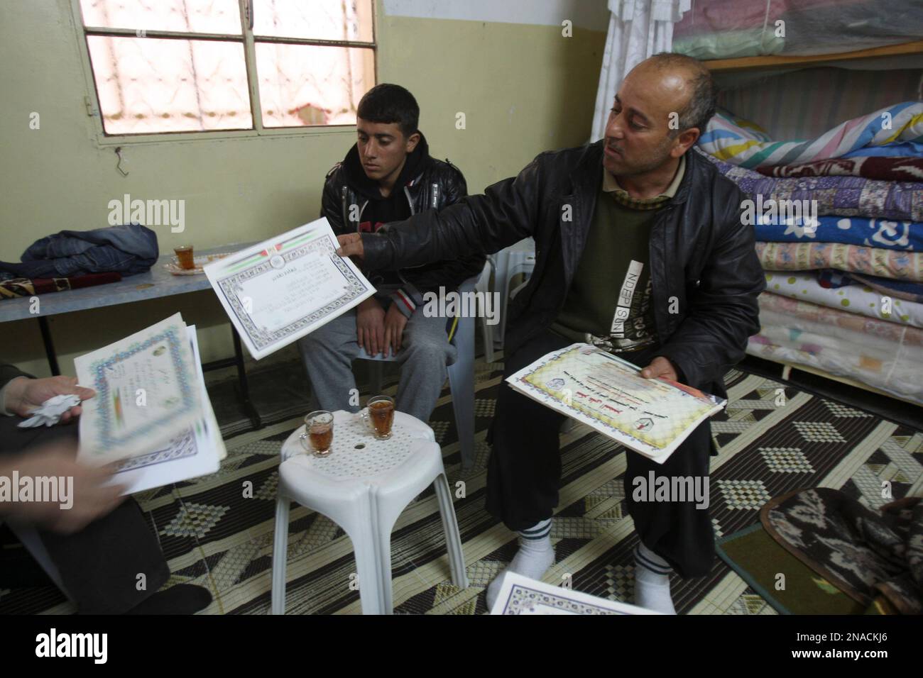 In this Monday, Jan 30, 2012 photograph, Mohammed Awad displays school ...
