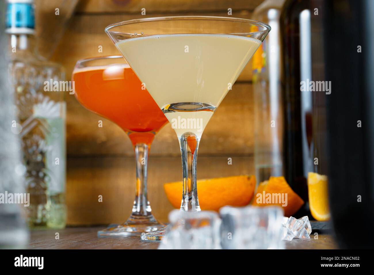 Two beautiful cocktails served on a wooden bar counter Stock Photo - Alamy