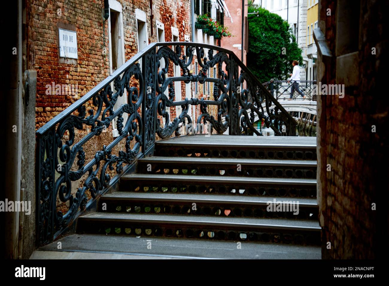 A close-up shot of a beautiful bridge with wrought iron railings in ...