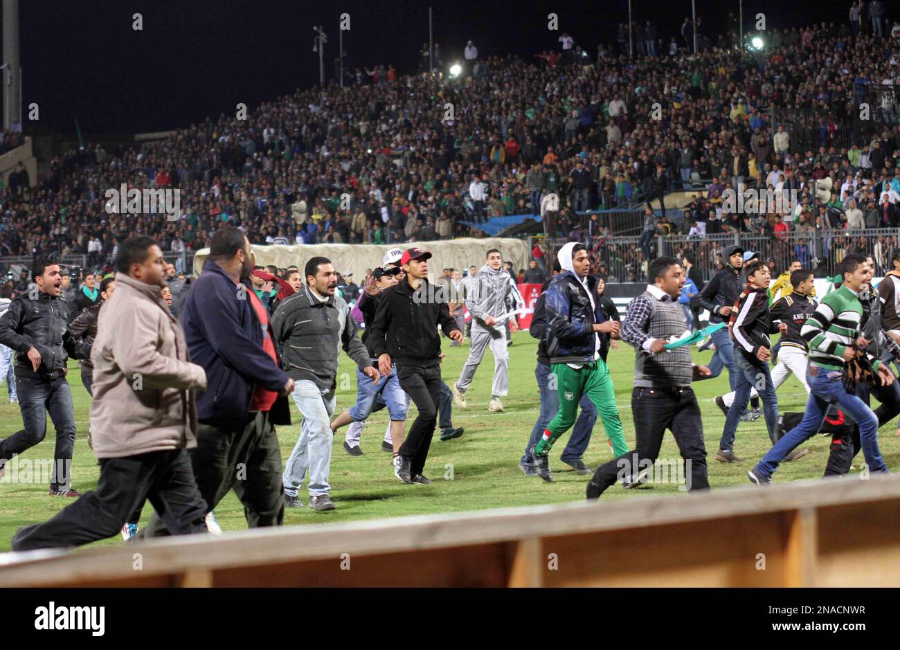 Egyptian fans rush into the field following Al-Ahly club soccer match ...