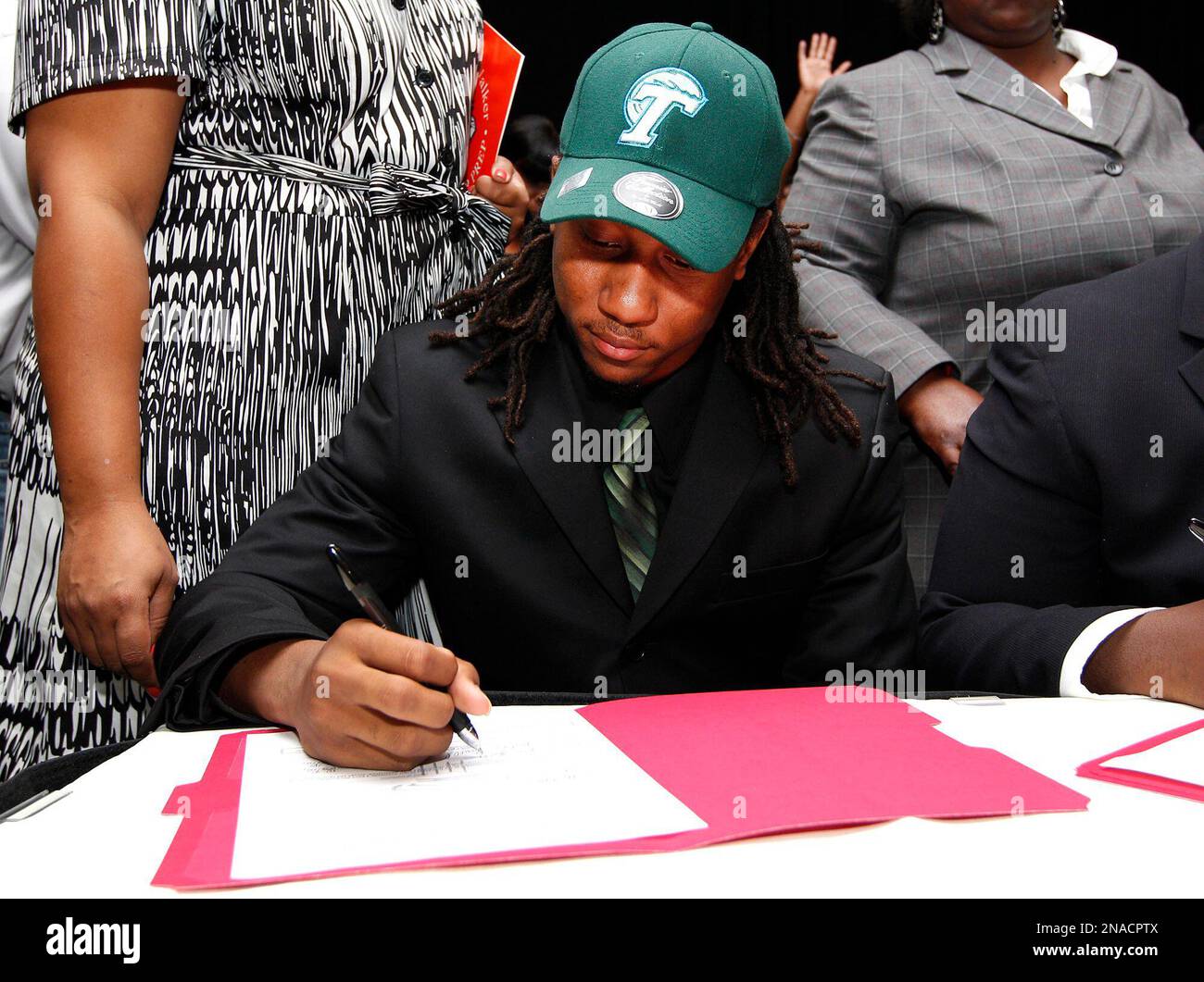 Devin Powell, of O. Perry Walker High School, signs a letter of intent ...