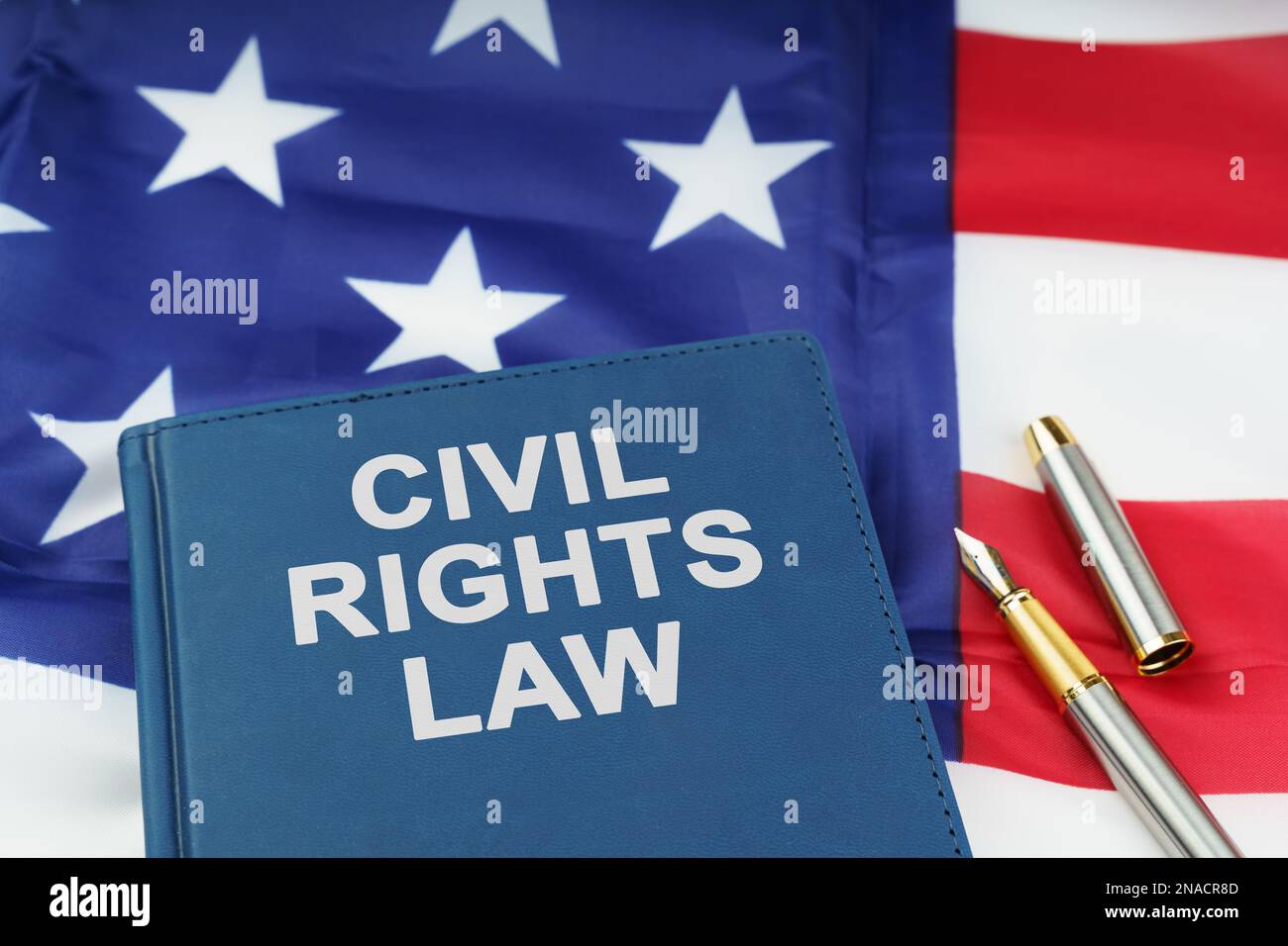 Law concept. On the US flag lies a pen and a book with the inscription ...