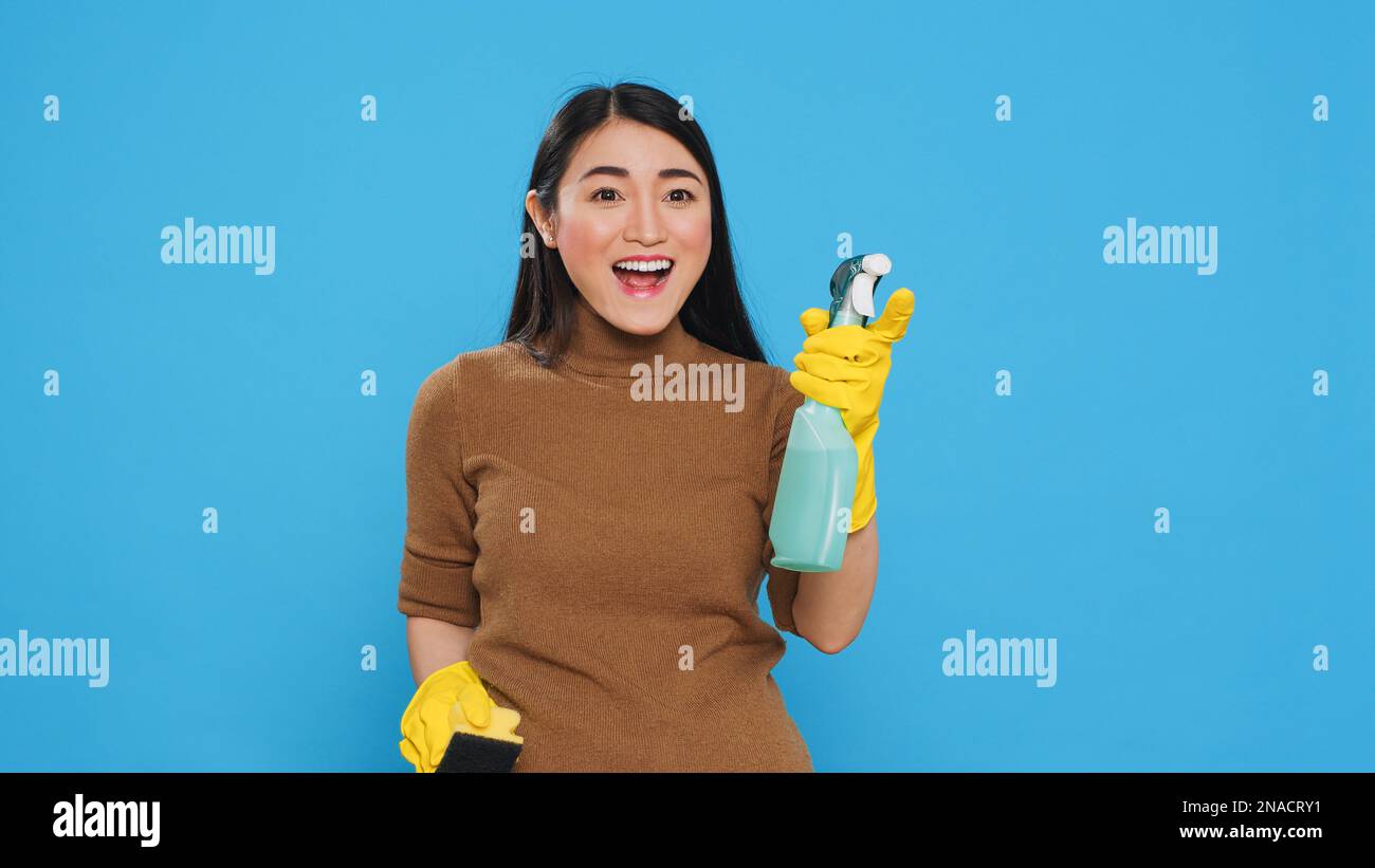 Professional housekeeper being amazed about how good is detergent spray ...