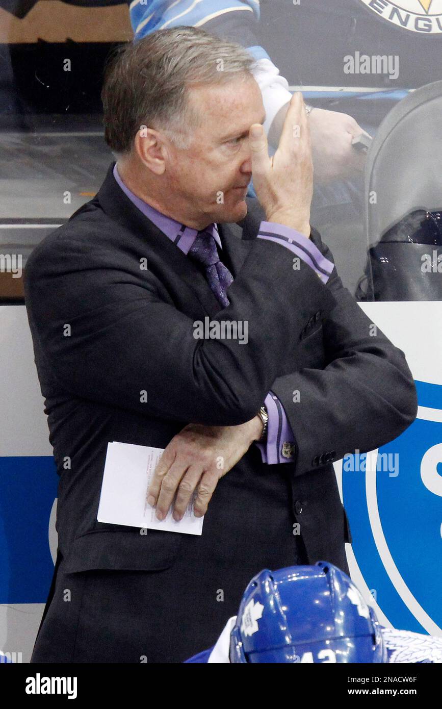 Toronto Maple Leafs coach Ron Wilson stands behind his bench and ...