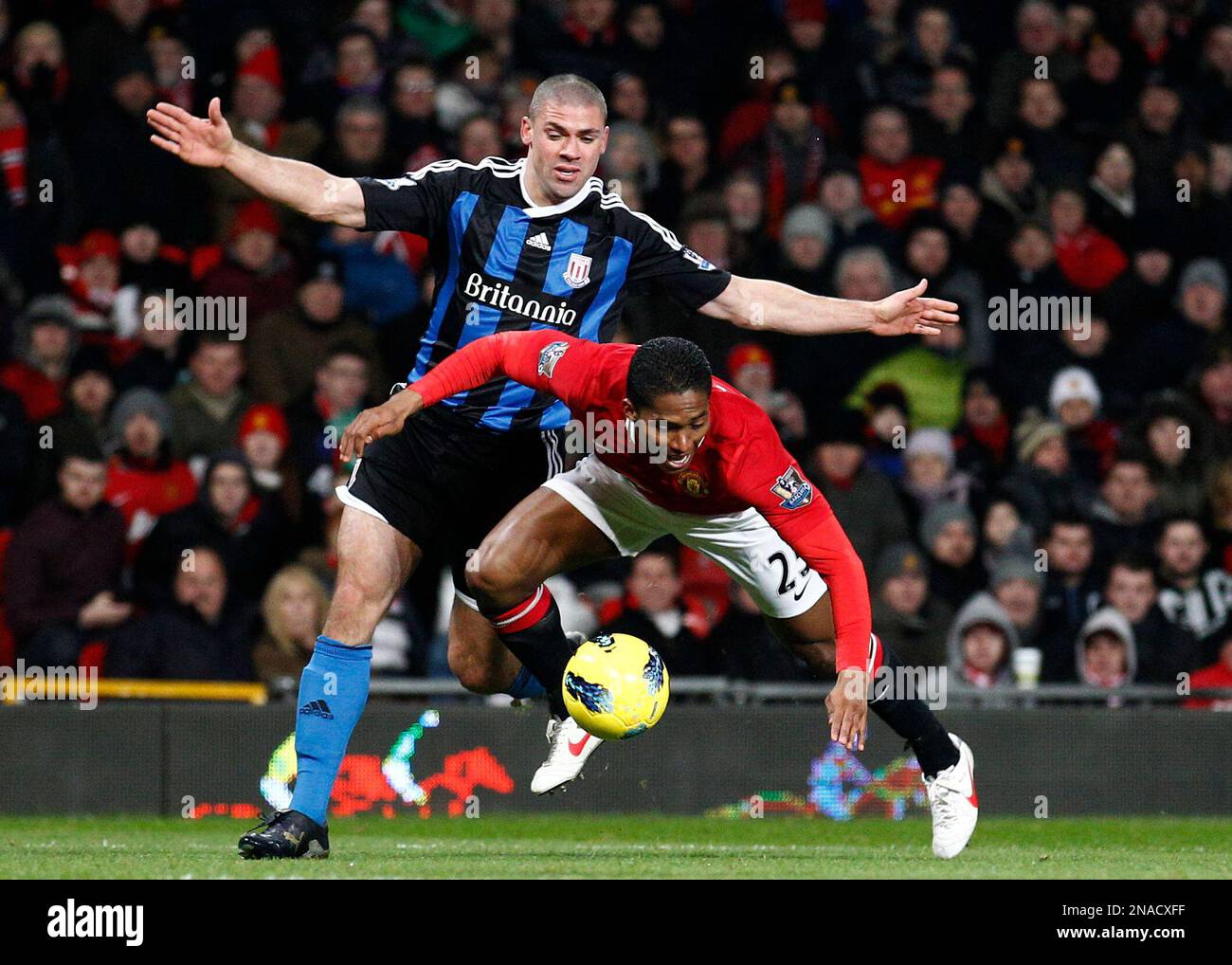 Manchester United's Antonio Valencia, right, is brought down for a ...
