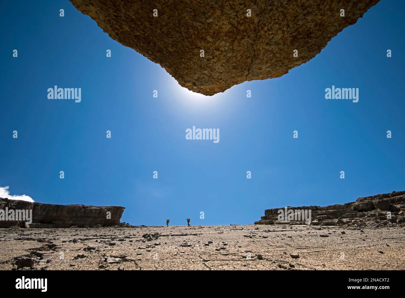 Expedition team members stand on a cliff's edge during their trek toward Dark Star, a limestone ...
