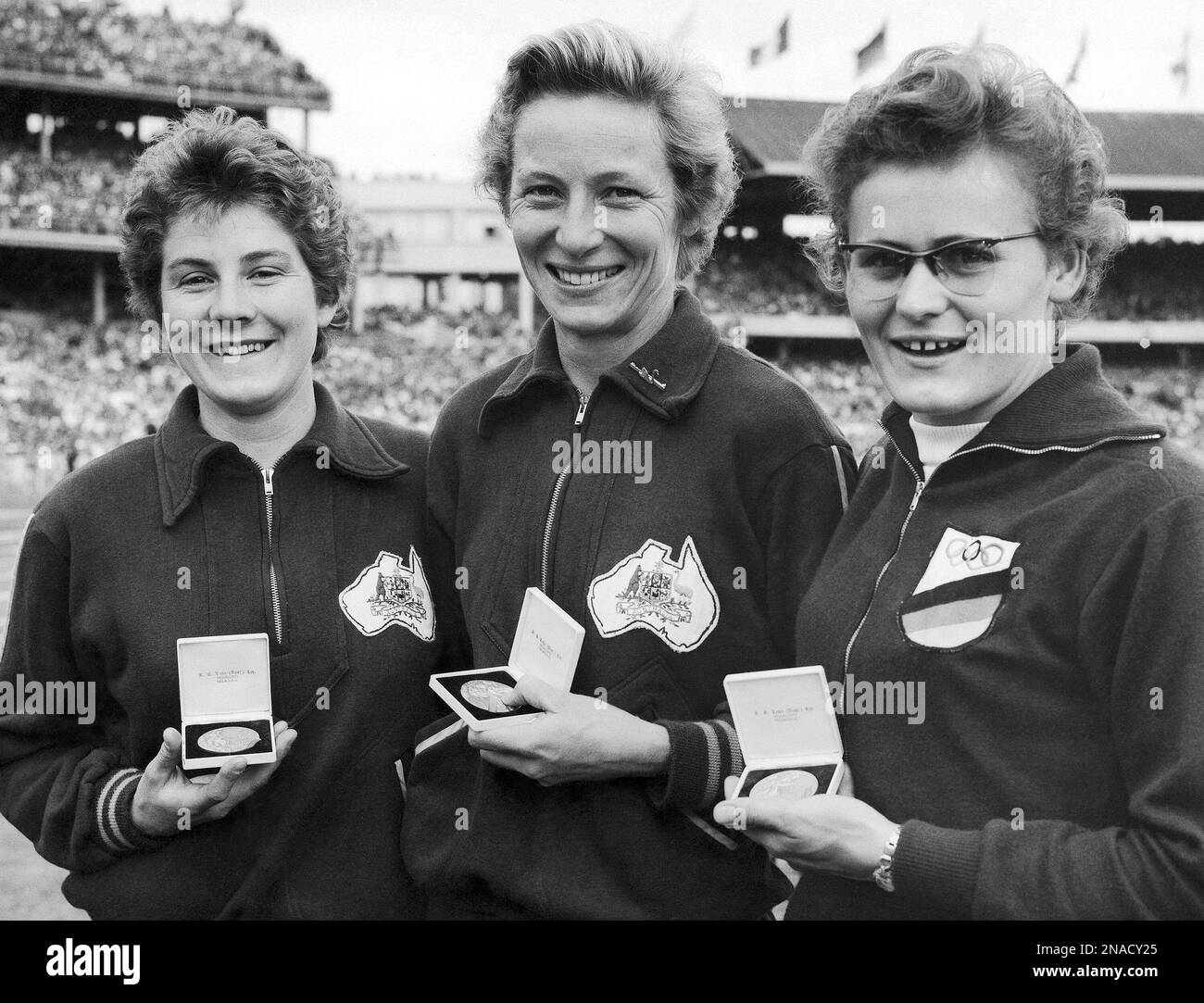 Showing their medals are the smiling winners of the Women's 80 meters ...