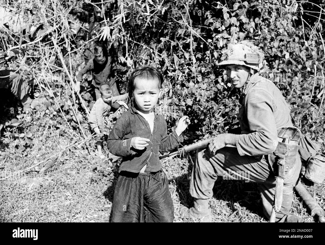 Vietnamese child is followed out of jungle by another child as a U.S ...