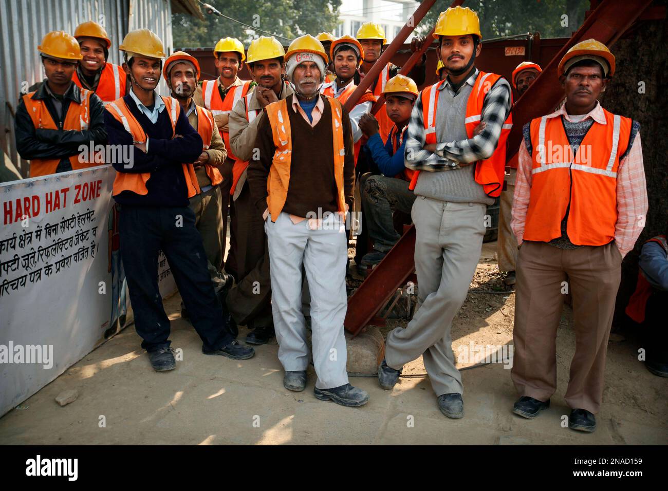 Indian laborers stand together and watch as the main boring machine is ...