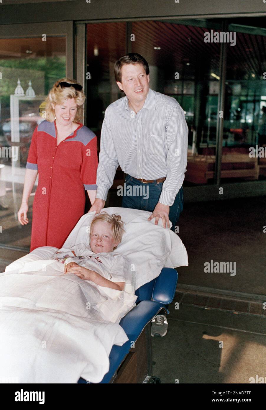 Albert Gore III is escorted out of the Johns Hopkins Hospital by ...