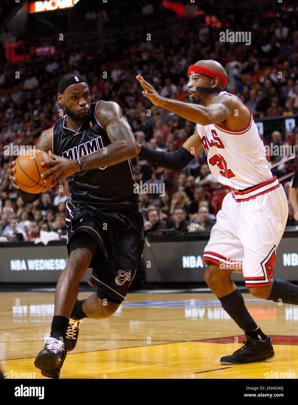 Miami Heat forward LeBron James, left, drives to the basket against ...