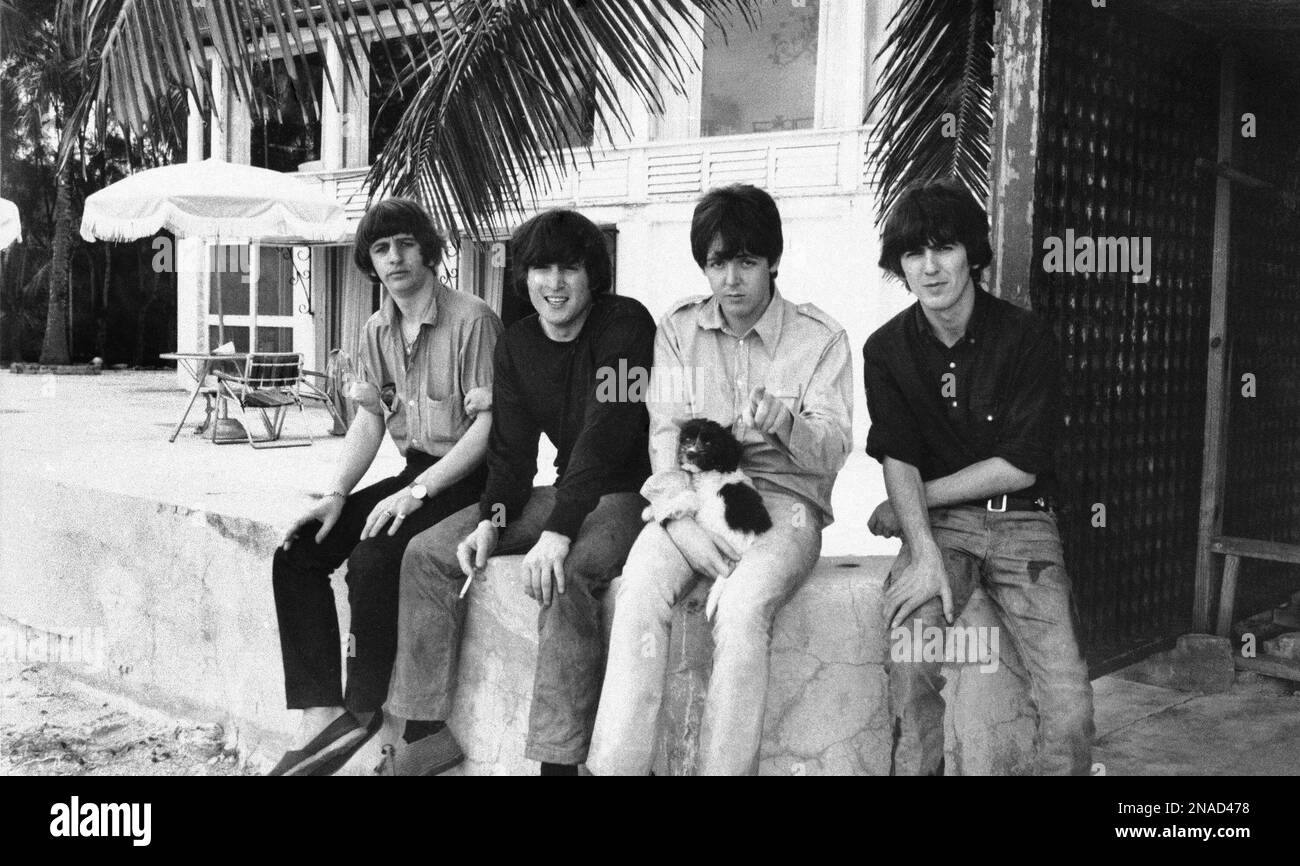 The Beatles sit on a stone fence in Nassau, Bahamas on Feb. 22, 1965 ...