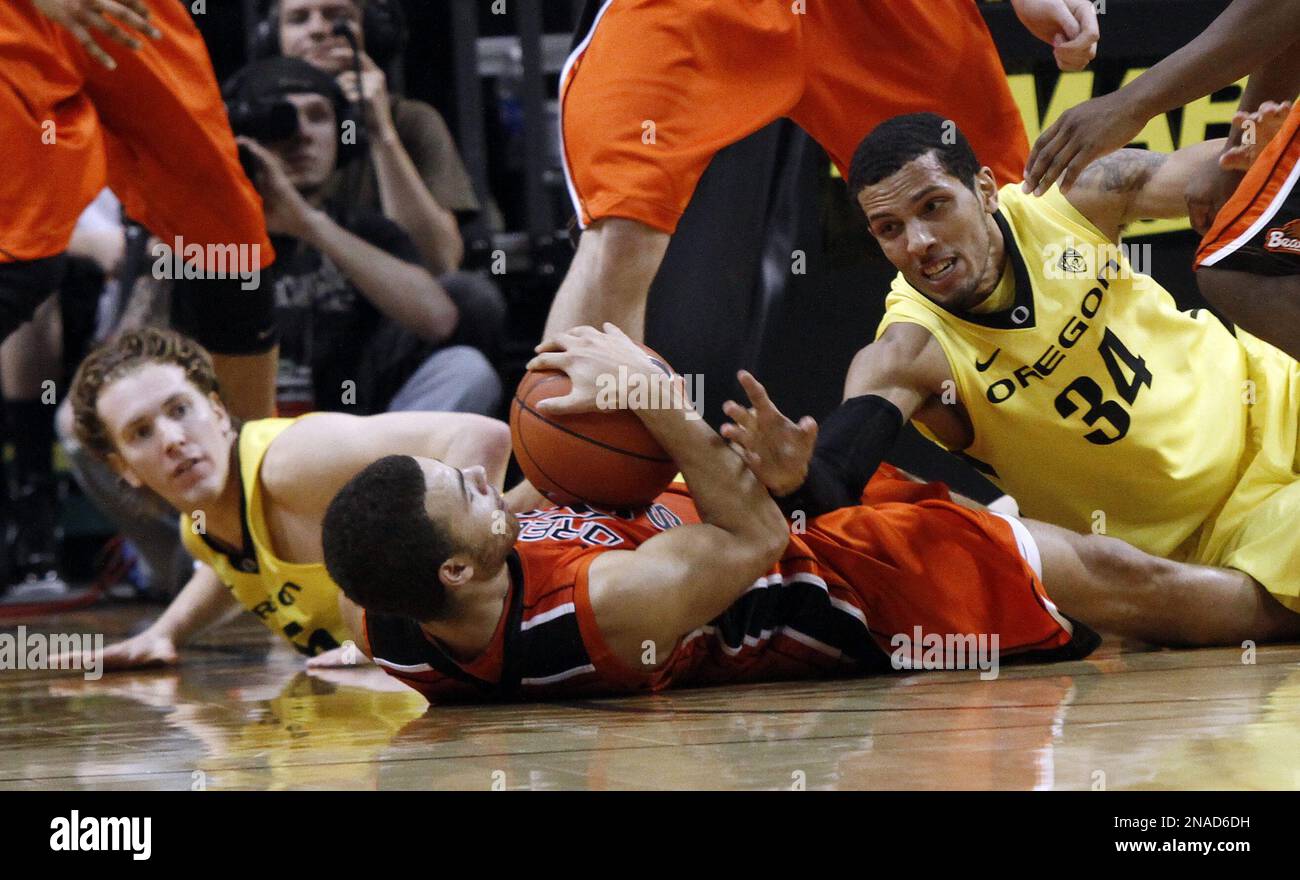 Oregon forward Devoe Joseph, right, dives in on Oregon State guard ...