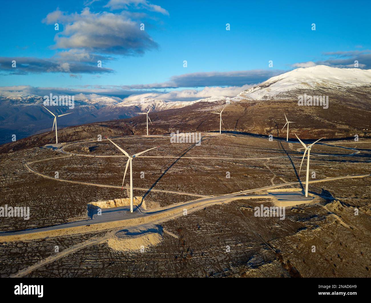 Windmills on the hills during sunset. Renewable energy, green energy ...
