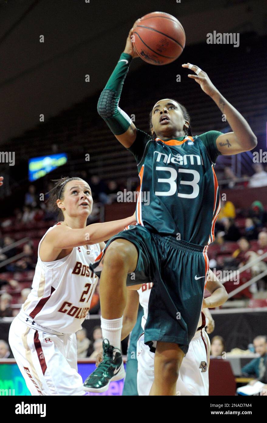 Miami's Suriya McGuire (33) drives past Boston College's Kristen ...
