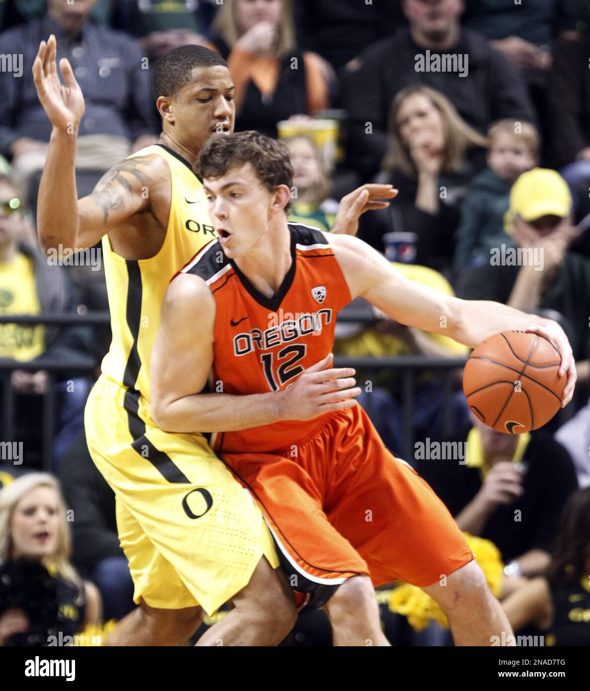 Oregon State forward Angus Brandt, right, drives on Oregon center Tony ...