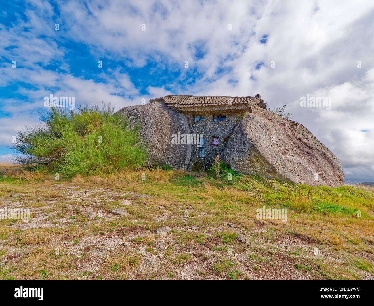 Boulder house or Casa do Penedo, a house built between huge rocks on ...