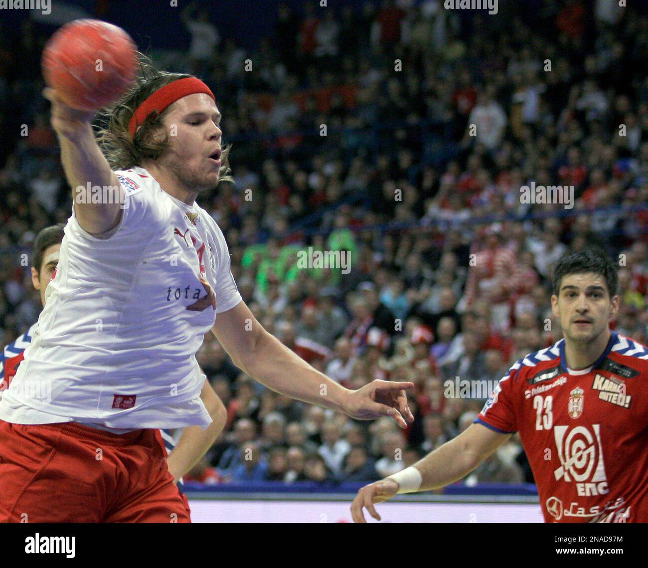 Denmark's Mikkel Hansen, left, takes a shot at goal as Serbia's Nenad ...