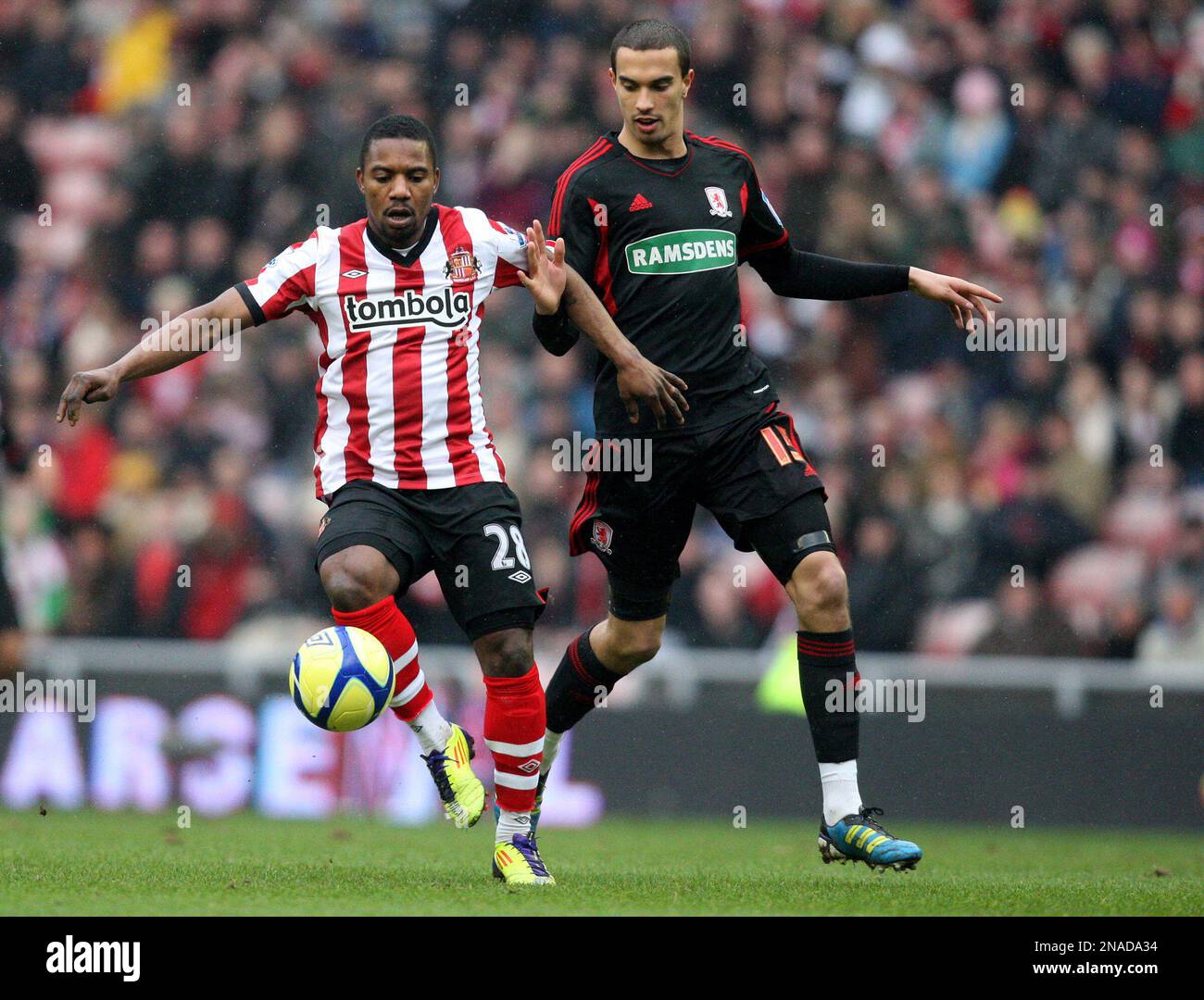 Sunderland's Stephane Sessegnon, left, vies for the ball with ...
