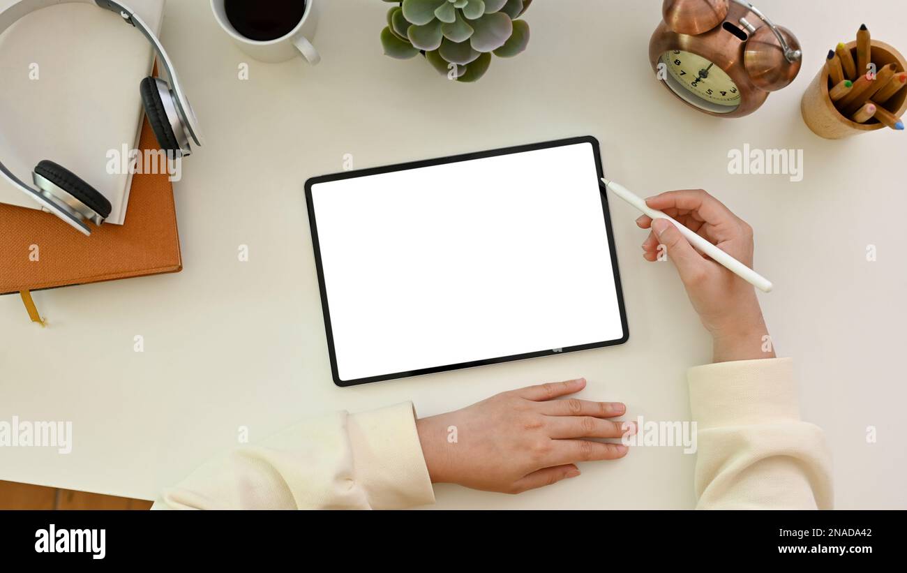 A female using a digital tablet, designing her artwork, working at her ...