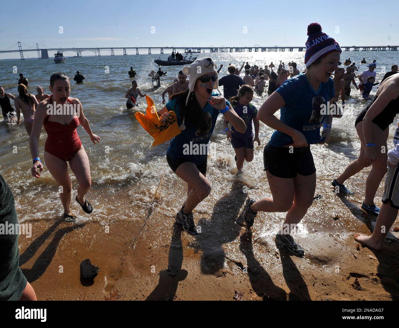 A group of plungers, including Lizzie Evans, center, run out of the ...
