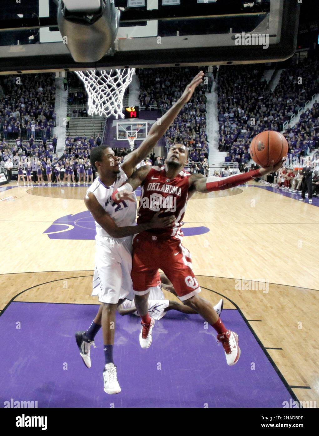 Oklahoma forward Romero Osby (24) puts up a shot under pressure from ...