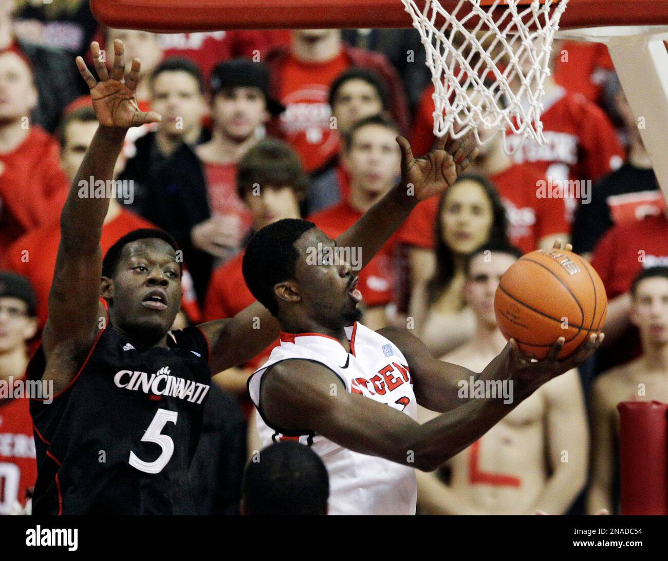 Rutgers' Dane Miller, right, shoots past Cincinnati's Justin Jackson (5 ...