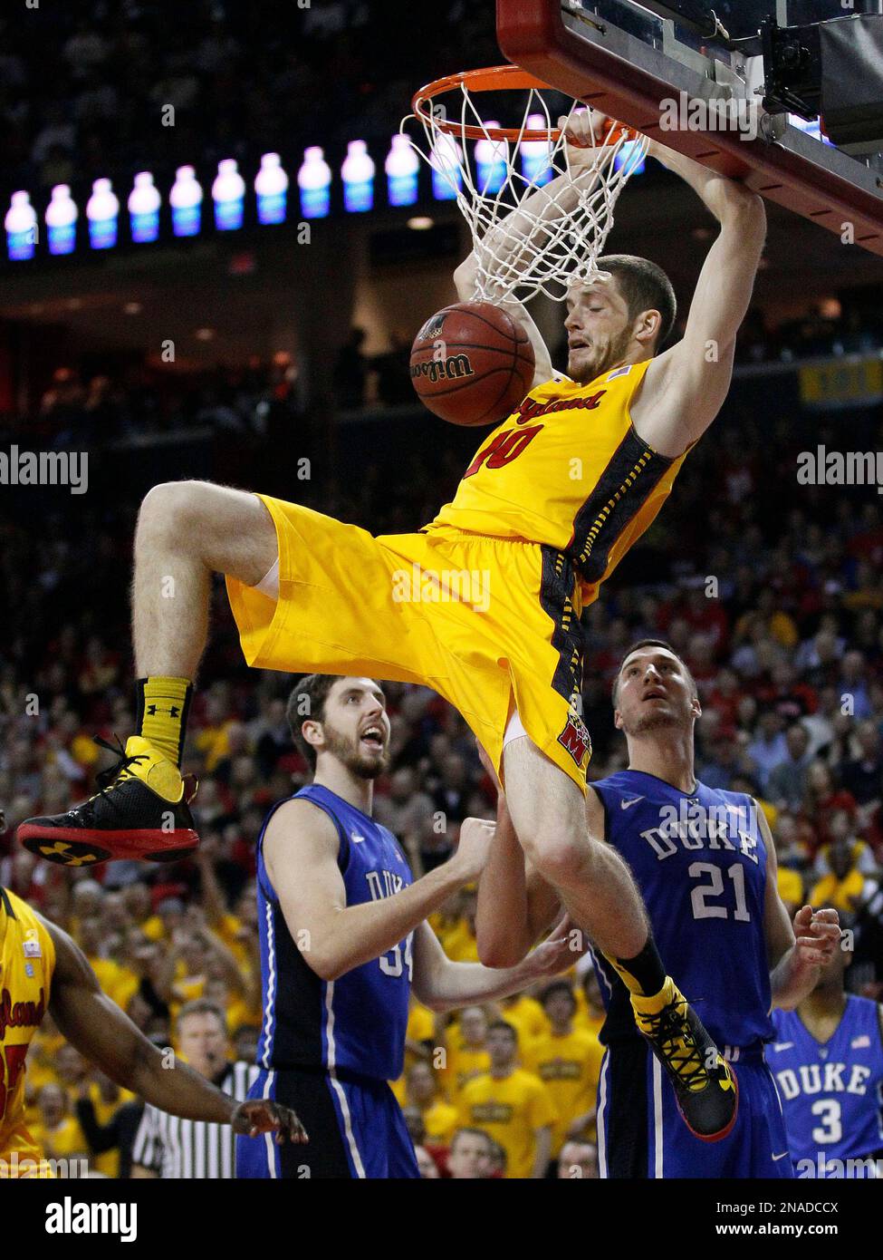Maryland center Berend Weijs (10) dunks over Duke forwards Ryan Kelly ...