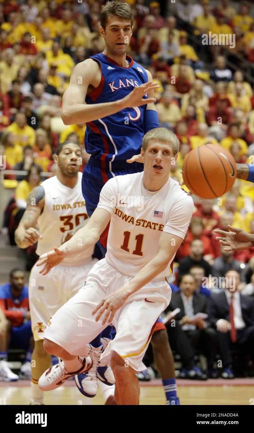 Iowa State guard Scott Christopherson (11) passes the ball under Kansas center Jeff Withey ...