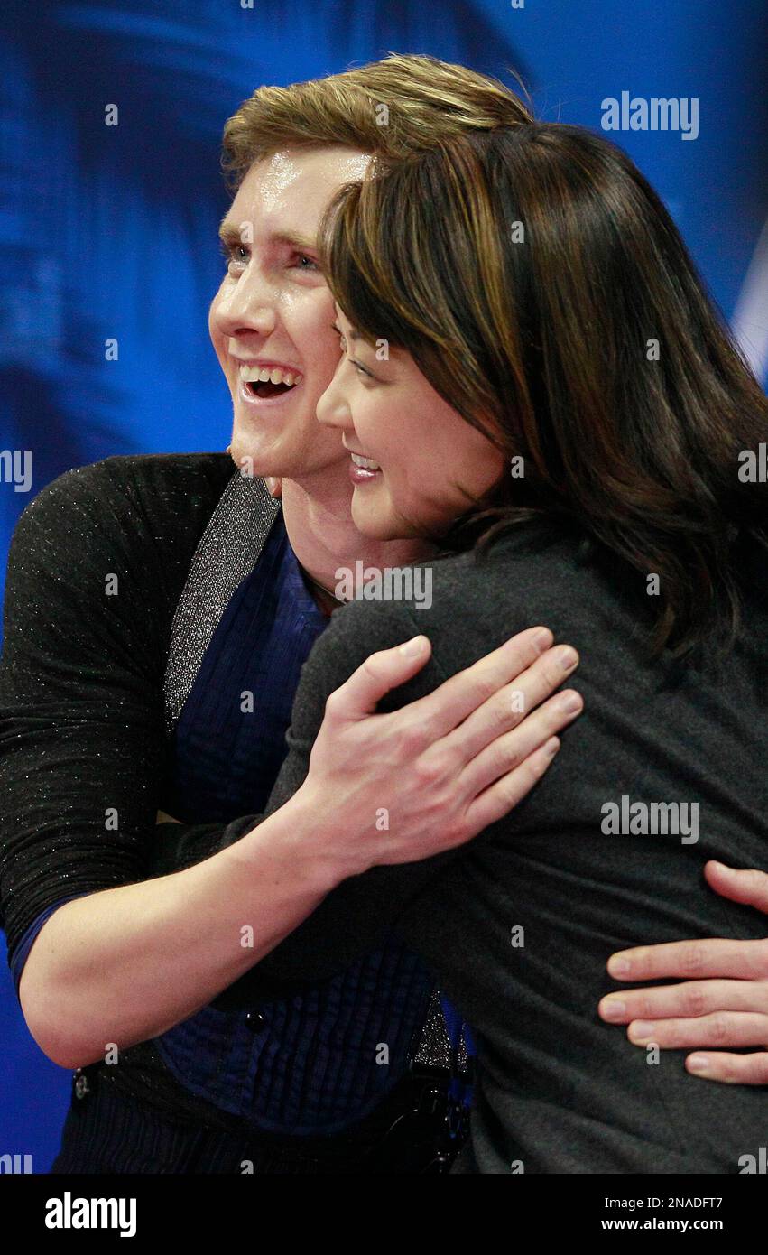 Jeremy Abbott, left, celebrates after seeing his scores next to coach ...