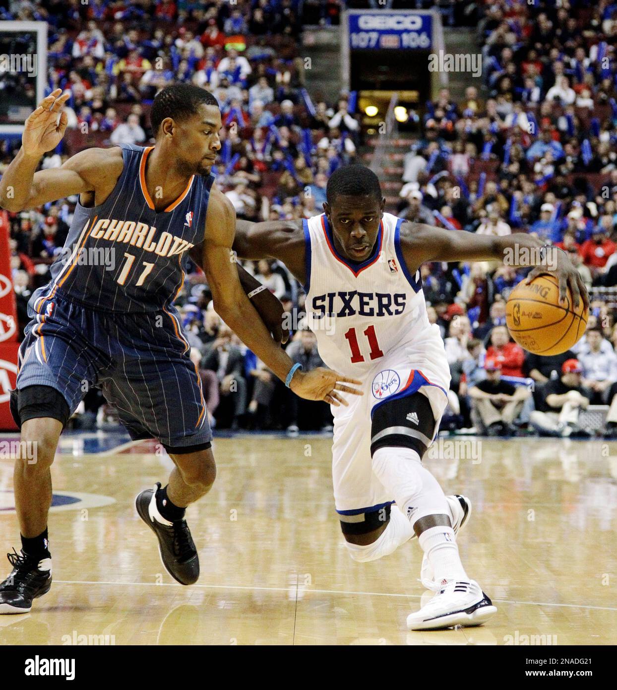 Philadelphia 76ers' Jrue Holiday (11) drives around Charlotte Bobcats ...