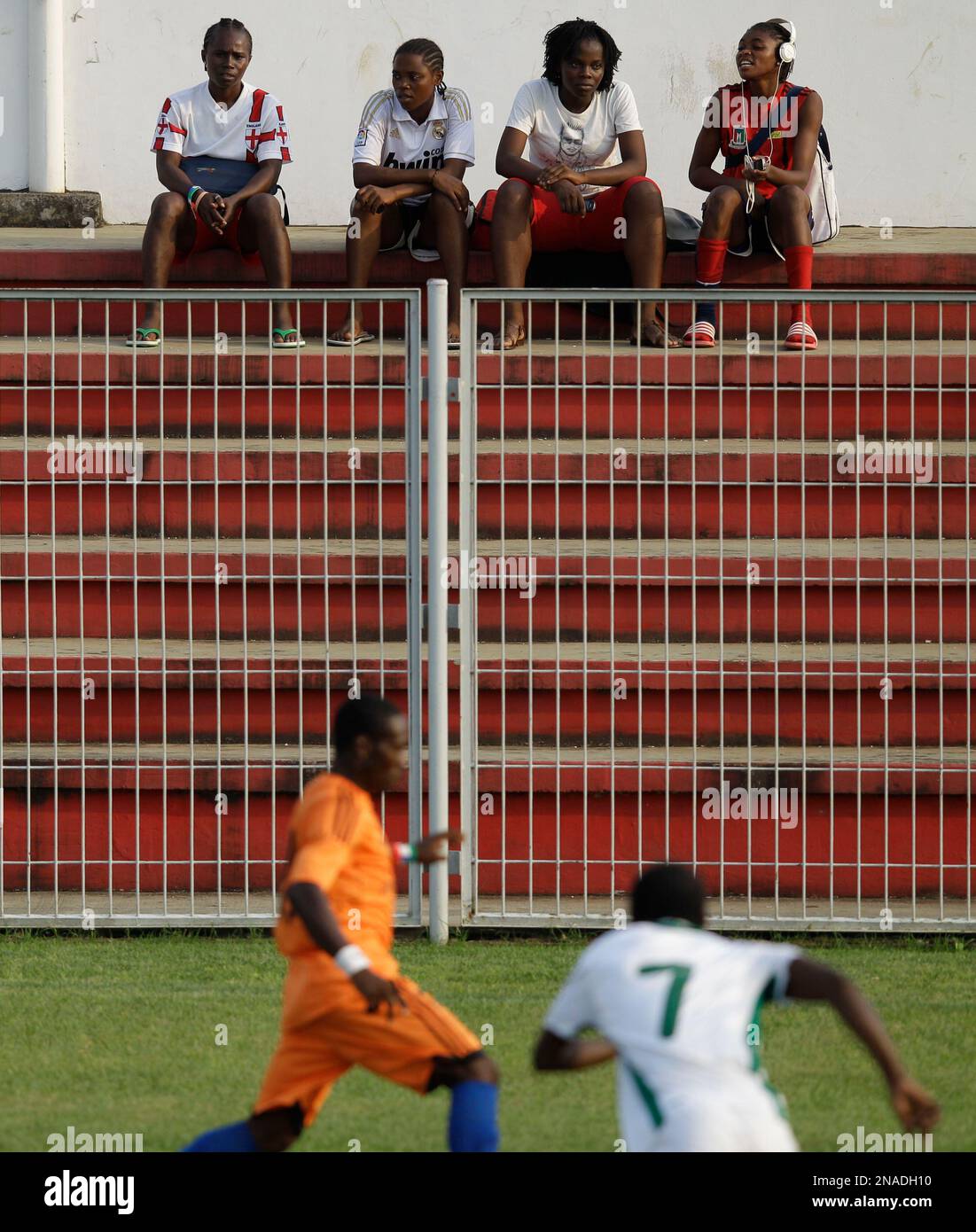 Female Equatoguinean soccer players watch as Ivory Coast's national ...