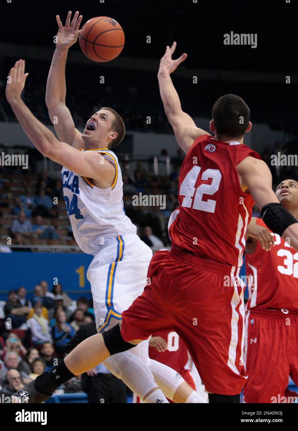 UCLA forward Travis Wear, left, shoots the ball as Utah's Jason ...