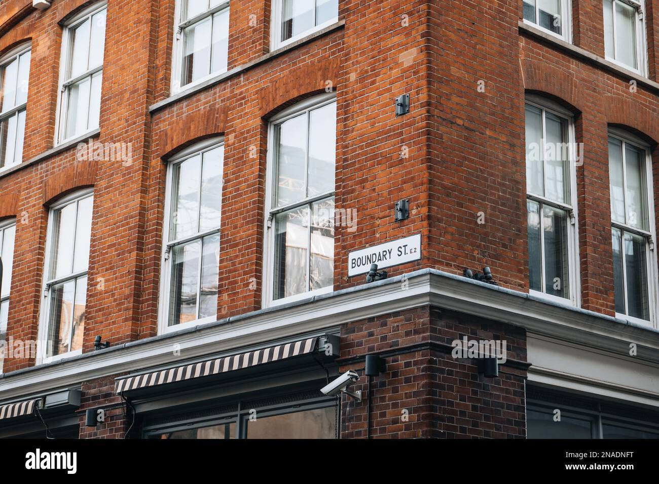 Street name sign on a wall of a red brick building on Boundary Street ...