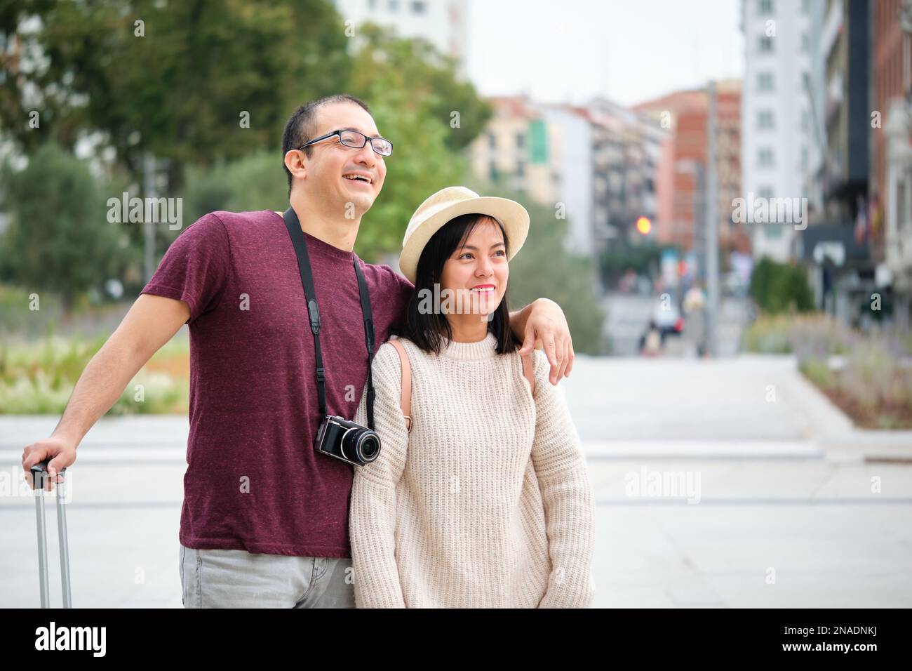 Happy multiracial couple of tourists exploring the city together Stock ...