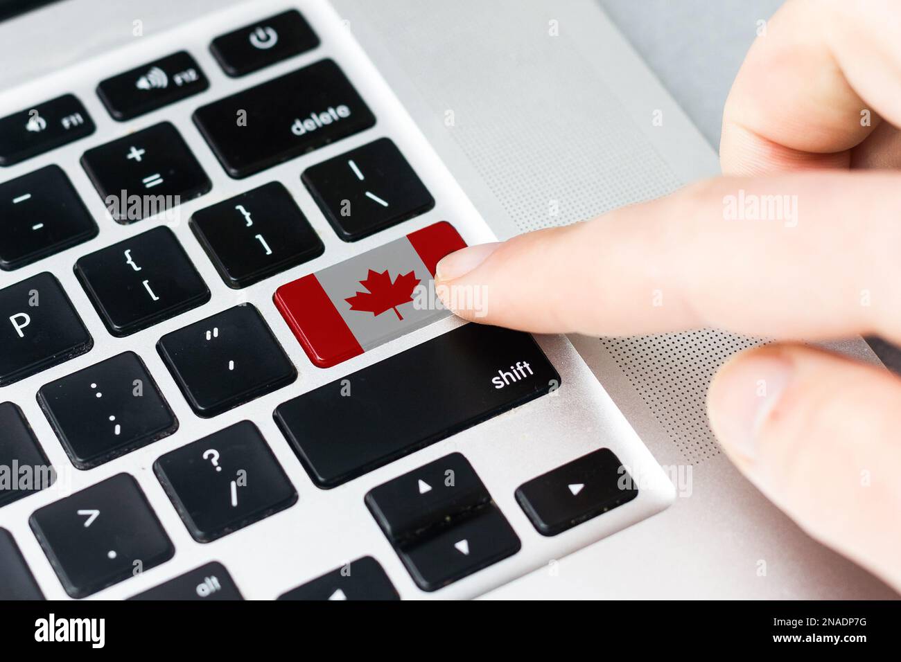 Computer key with the Canada on it. Male hand pressing computer key ...