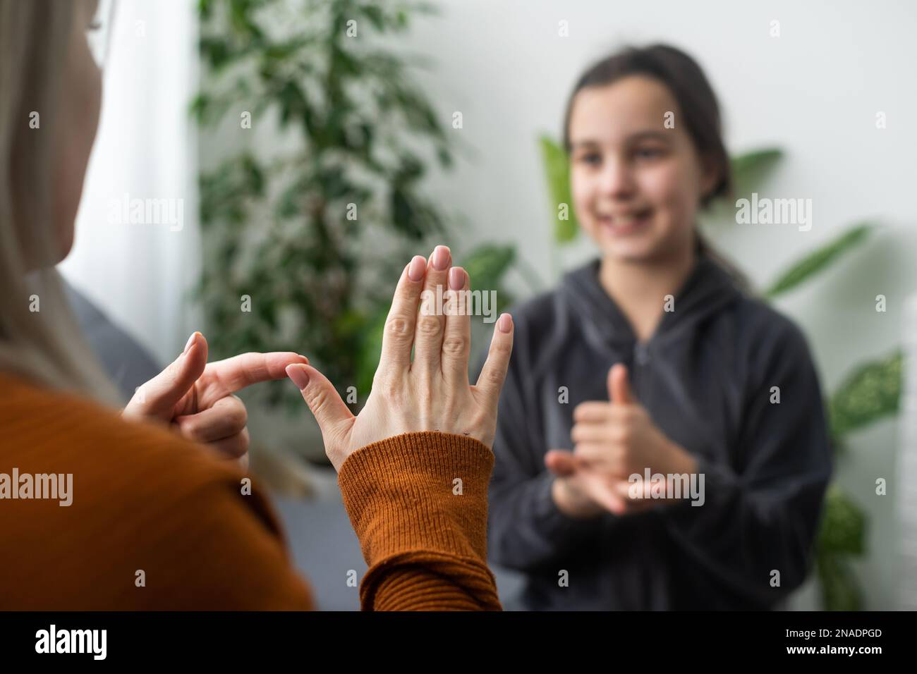Small Caucasian teen girl child do articulation exercises with caring ...