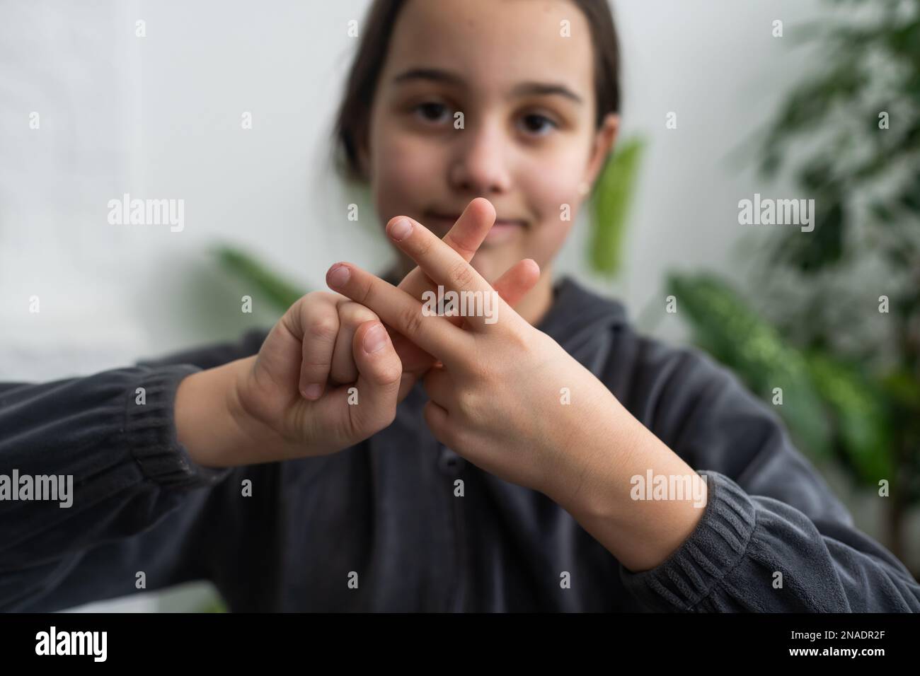 A smiley teenage girl hand sign Stock Photo - Alamy