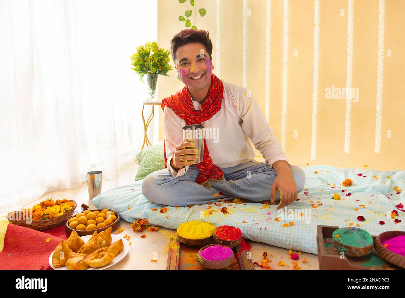A young man holding drinking bhang on holi festival Stock Photo - Alamy