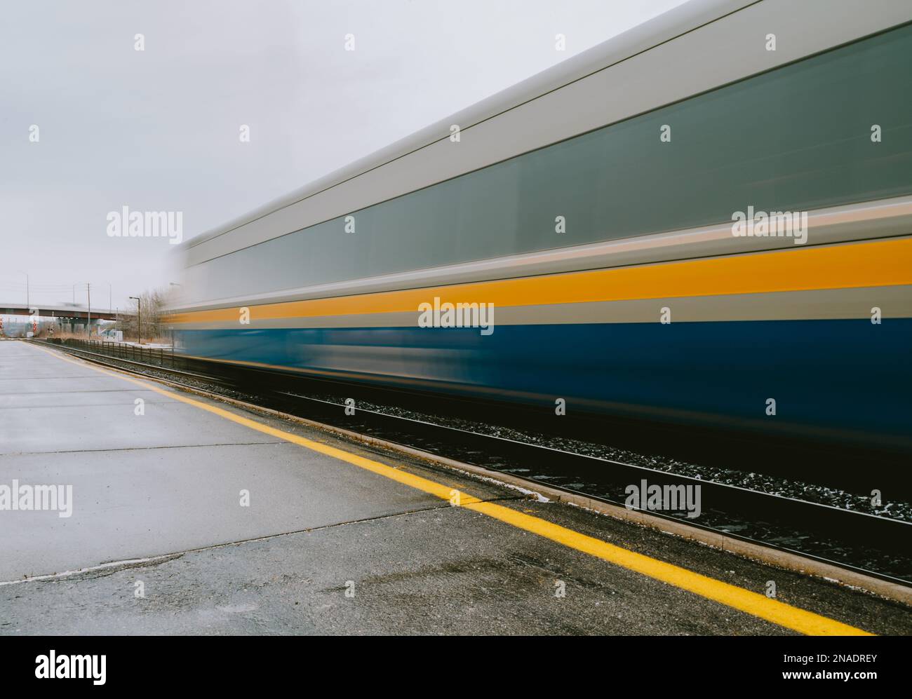 Blurred fast moving passenger train travelling down the tracks Stock ...