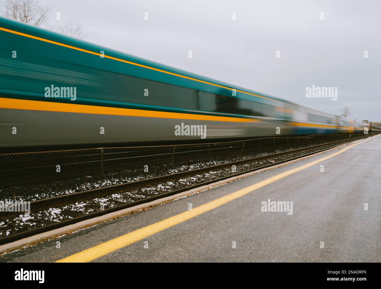 Blurred fast moving passenger train travelling down the tracks Stock ...