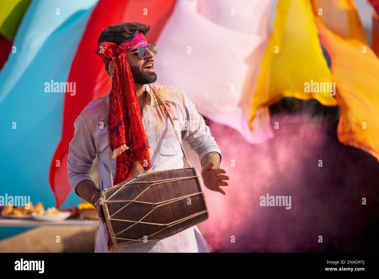 Man playing on a dhol, during holi celebrations Stock Photo - Alamy