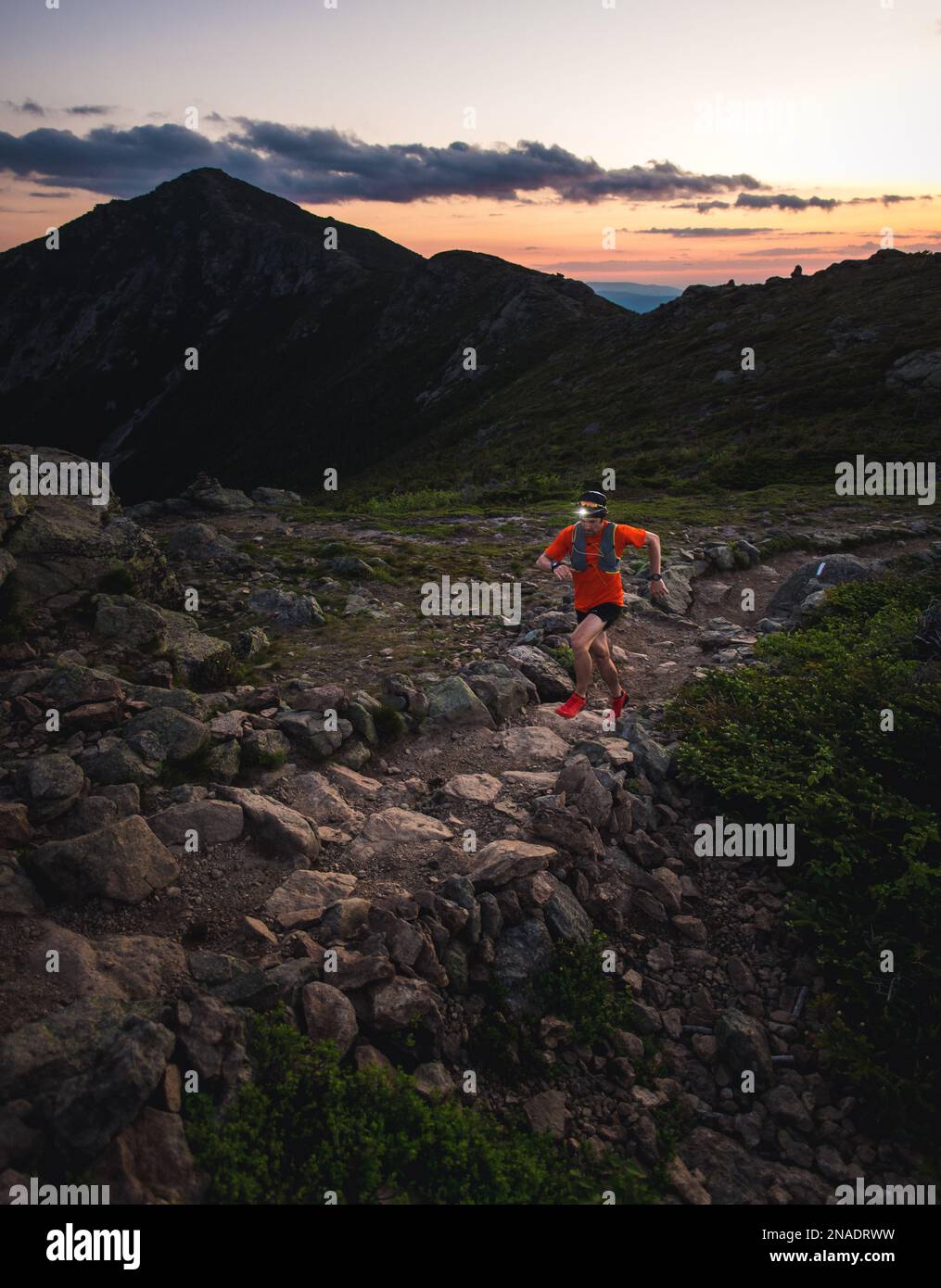Trail runner with headlamp running on the Franconia Ridge Stock Photo ...