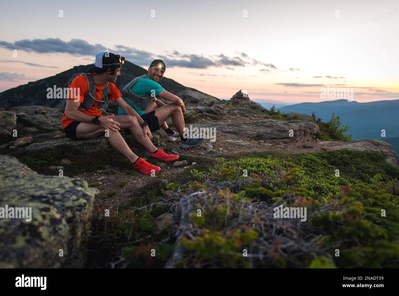Two men smiling and laughing while on trail run in mountains Stock ...