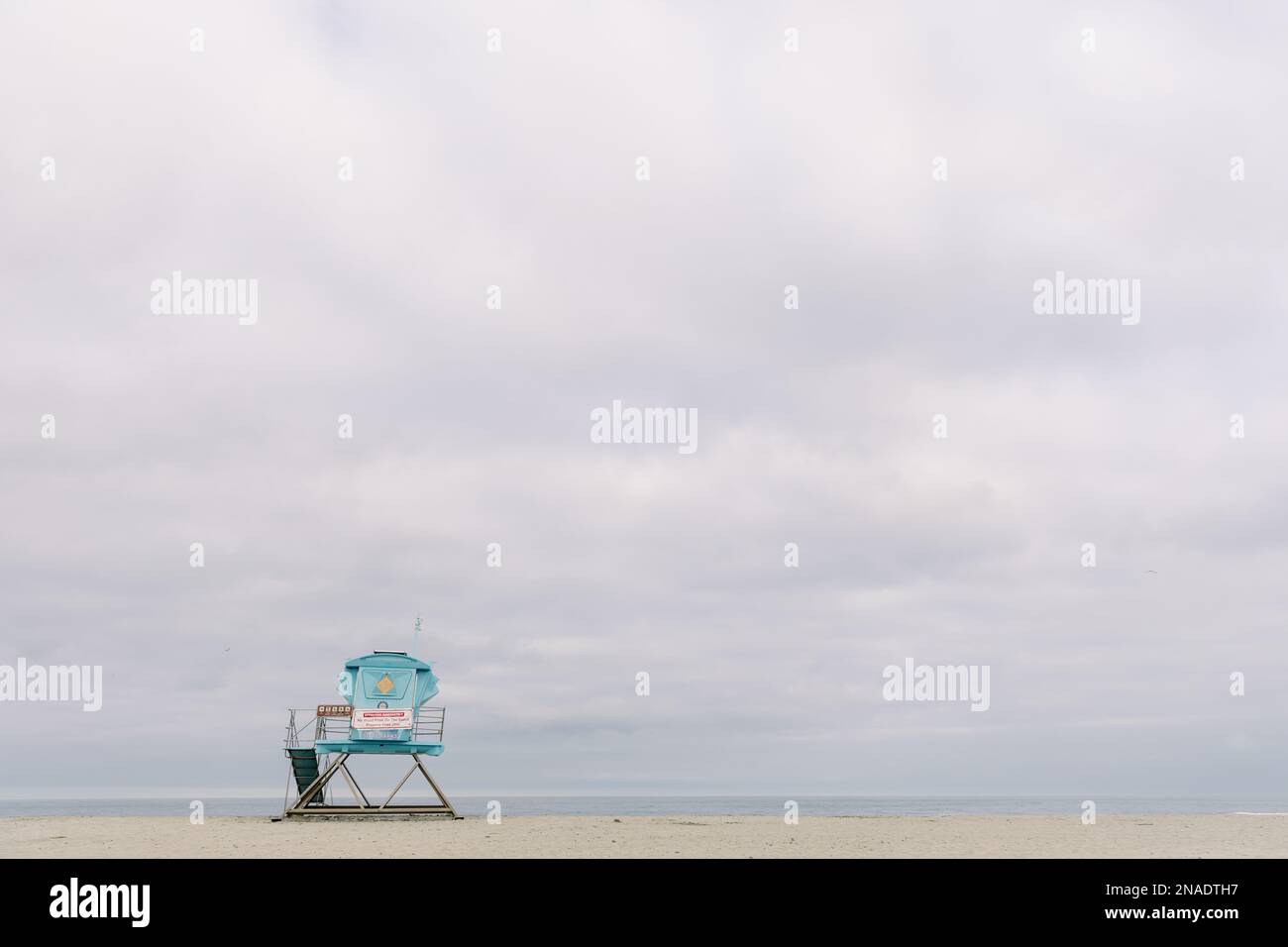 Fine art beach scene with lifeguard Tower and cloudy skies Stock Photo ...