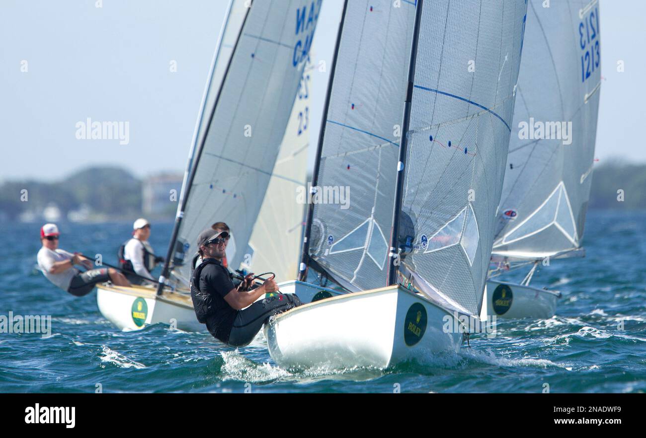 Canada's Jeff Roney leads a group of Finn sailboats towards a turn at ...